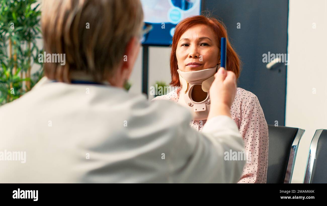 Asian patient with neck collar doing consultation with specialist ...