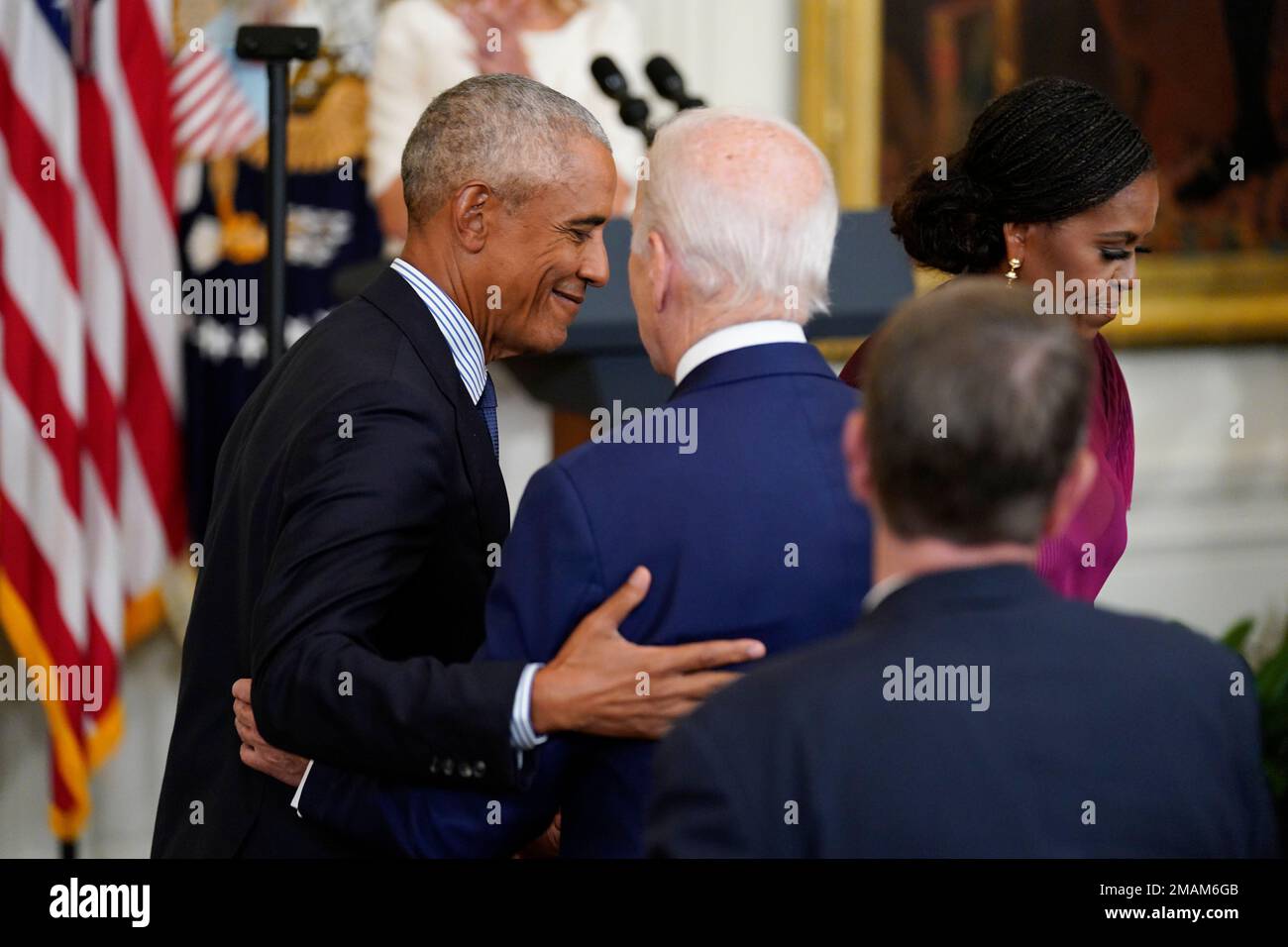 Former President Barack Obama hugs President Joe Biden as he and former ...