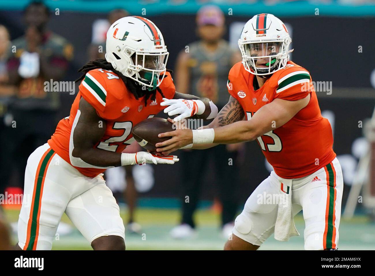 Miami quarterback Jake Garcia (13) hands off the football to running ...