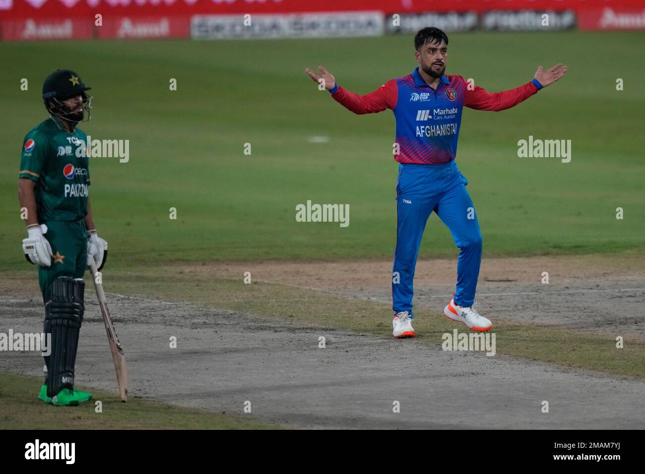 Afghanistan's Rashid Khan, right, celebrates the dismissal of Pakistan ...