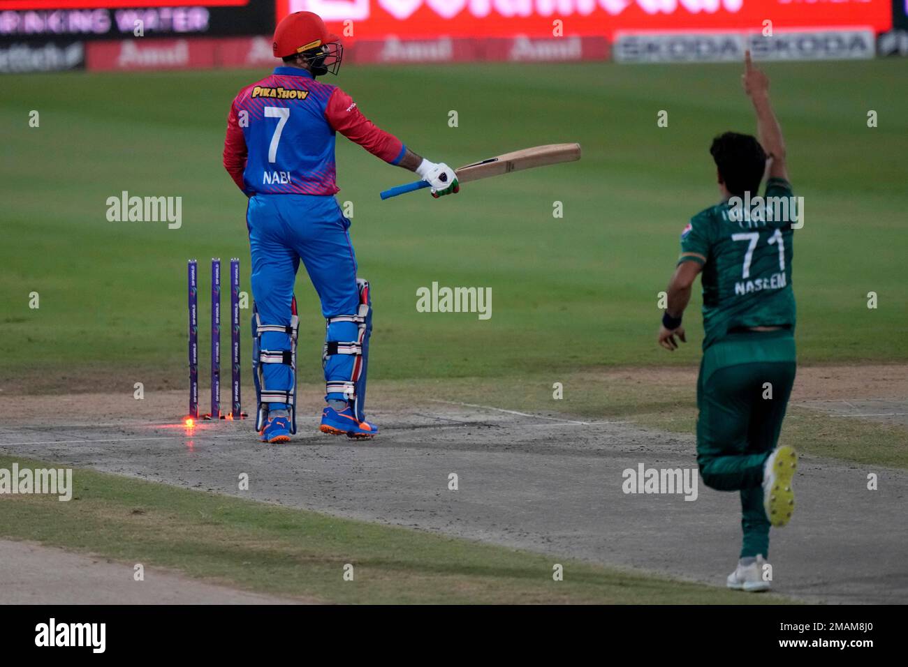 Afghanistan's captain Mohammad Nabi, left, reacts after he is bowled ...