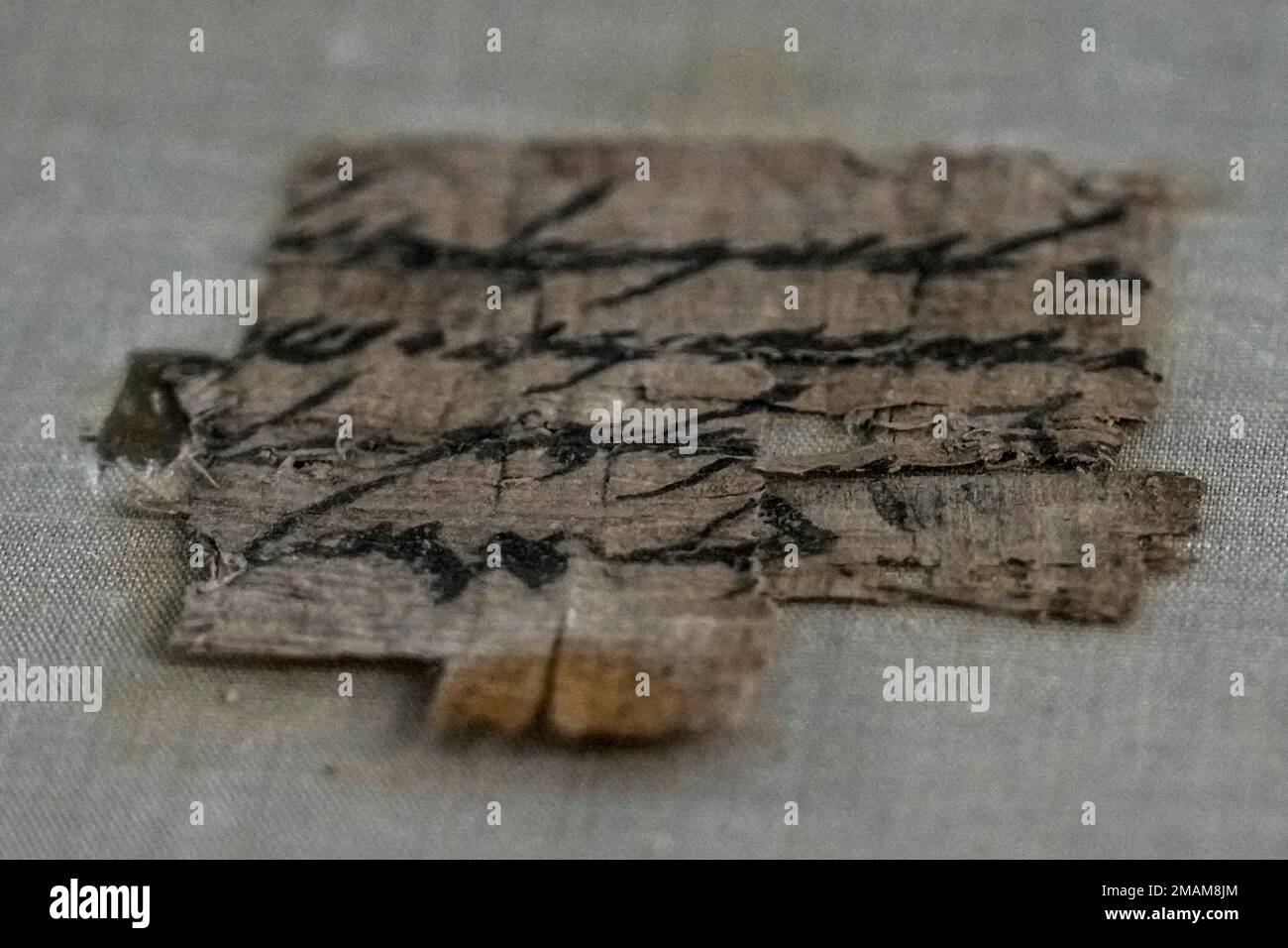 A scrap of papyrus is displayed at the Israeli Antiquities Authority ...