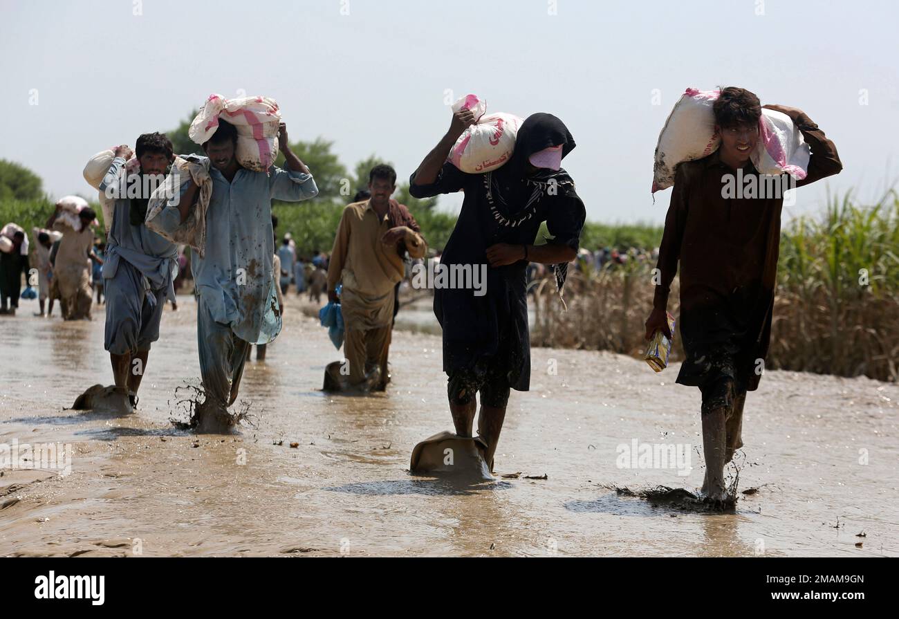 Victims of unprecedented flooding from monsoon rains receive relief aid ...