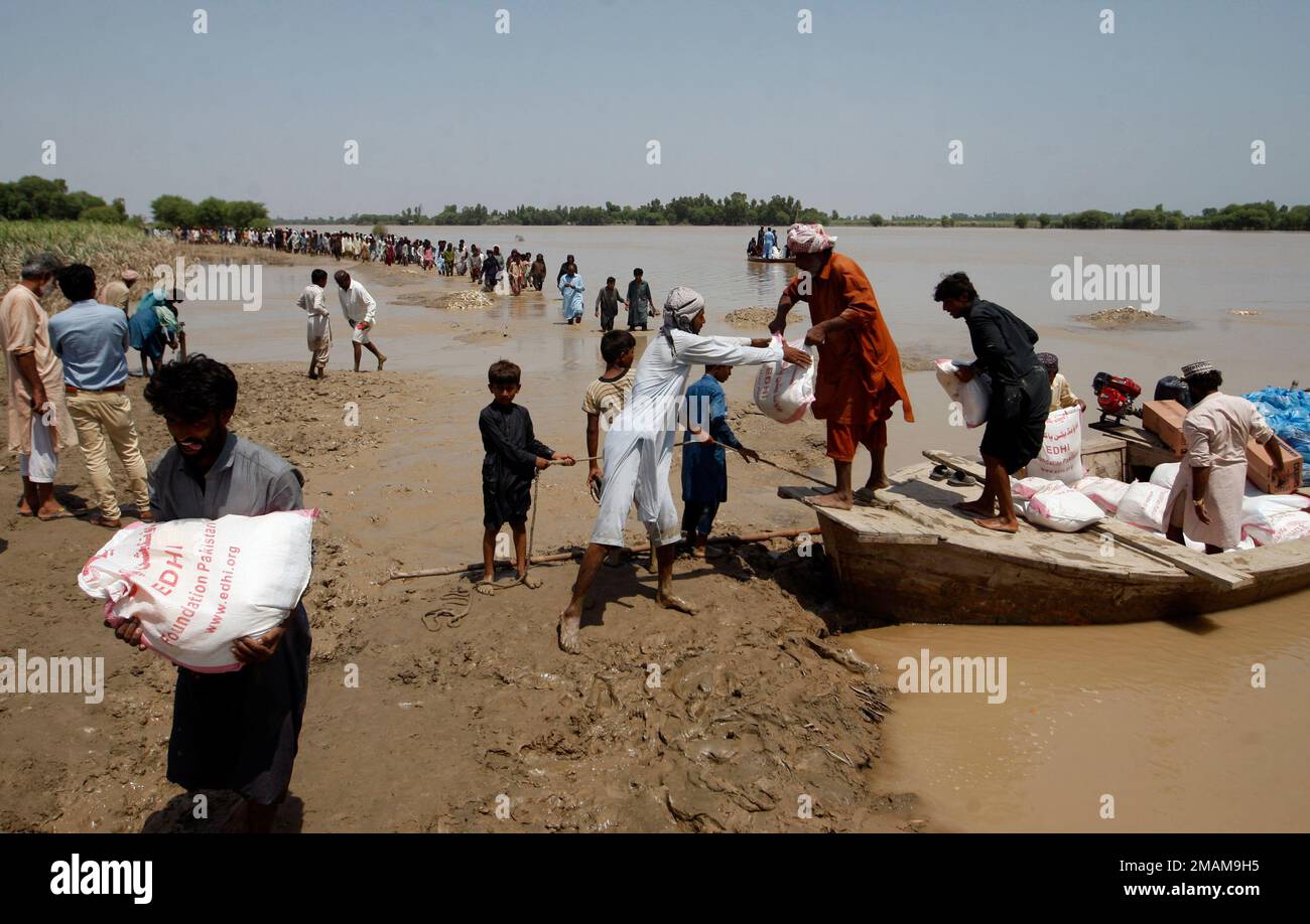 Victims of unprecedented flooding from monsoon rains receive relief aid ...