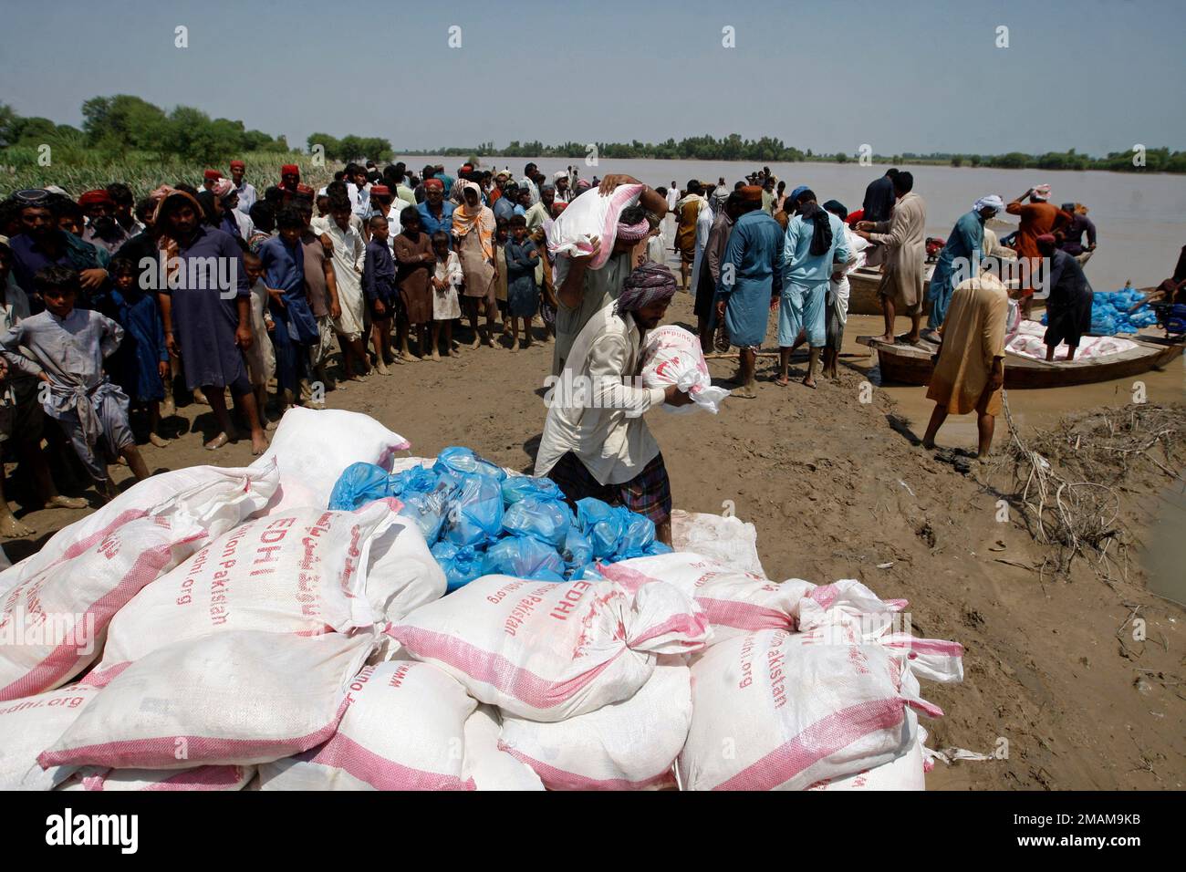 Victims of unprecedented flooding from monsoon rains receive relief aid ...