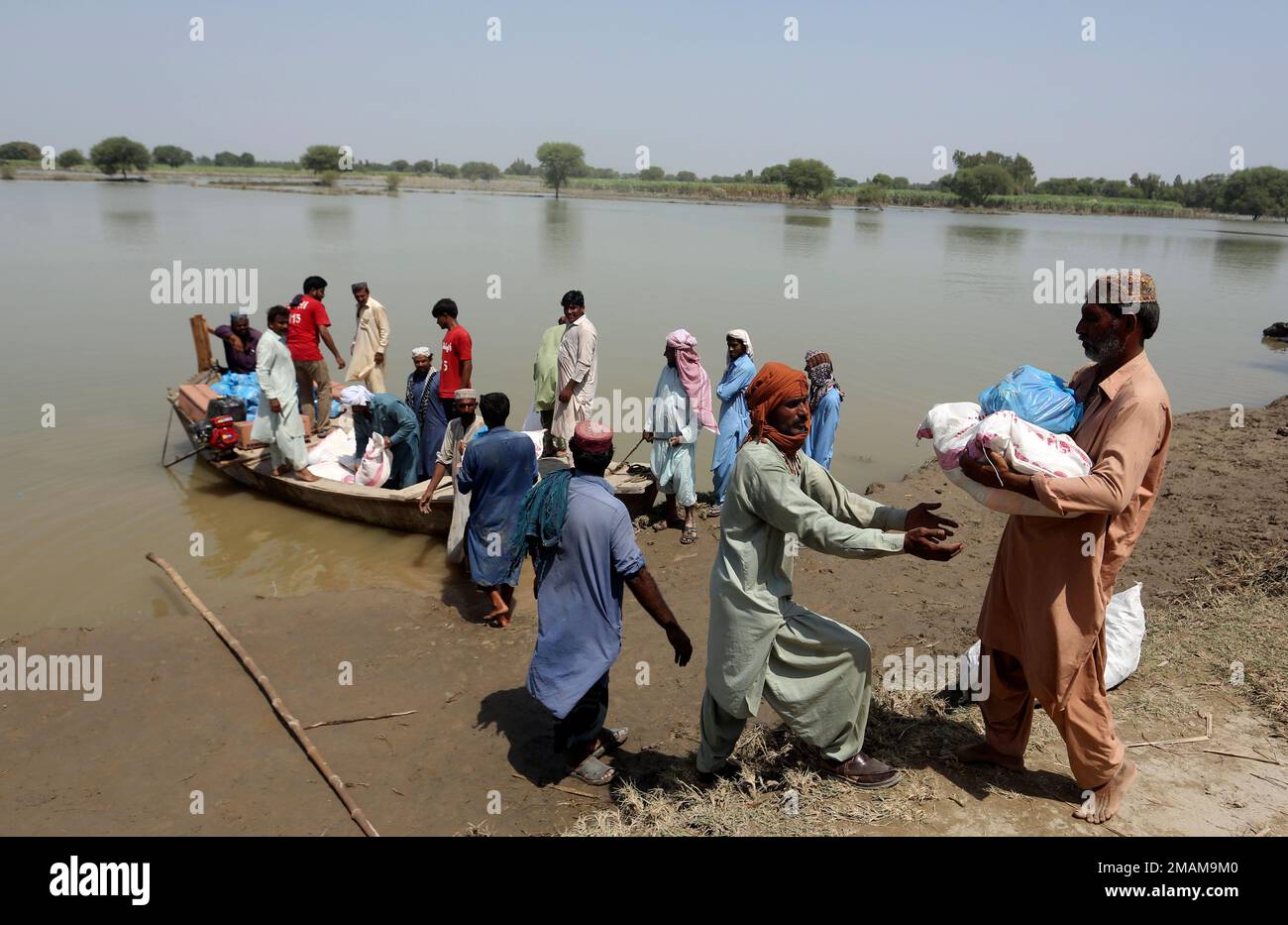 Victims of unprecedented flooding from monsoon rains receive relief aid ...