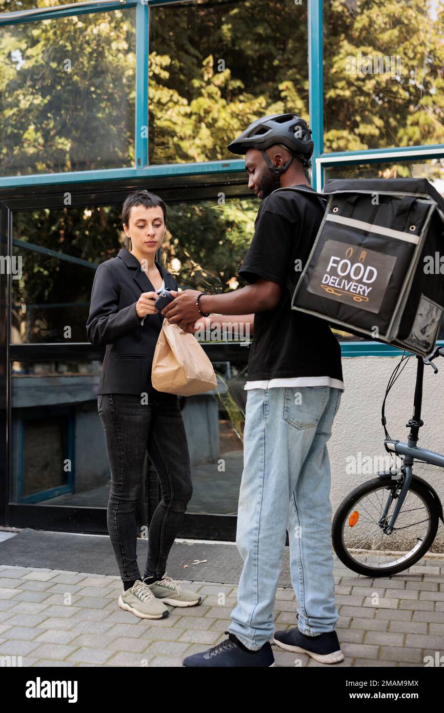 Customer paying for office food delivery service with credit card ...