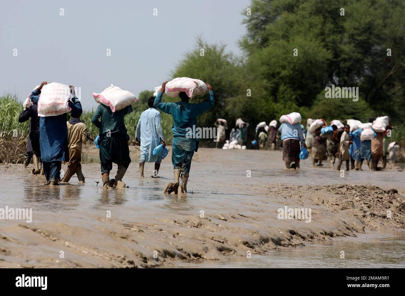 Victims of unprecedented flooding from monsoon rains receive relief aid ...