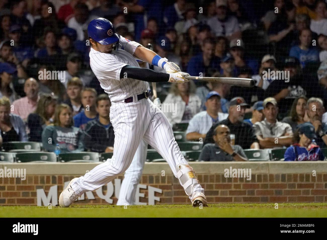 Chicago Cubs' Seiya Suzuki swings through a two-run home run off ...