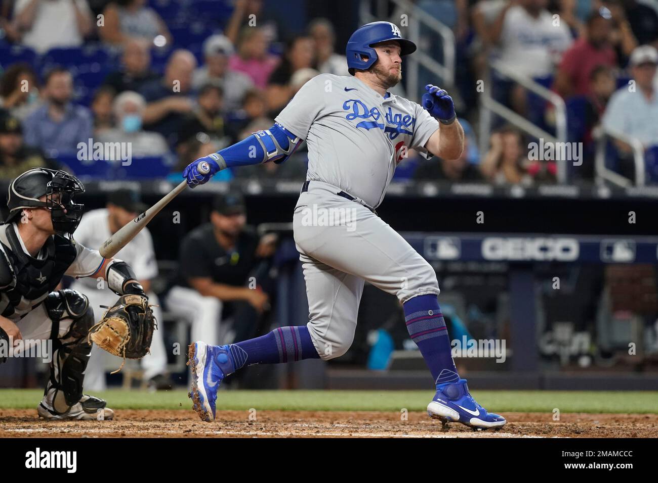 Los Angeles Dodgers' Max Muncy (13) follows his hit to center field ...
