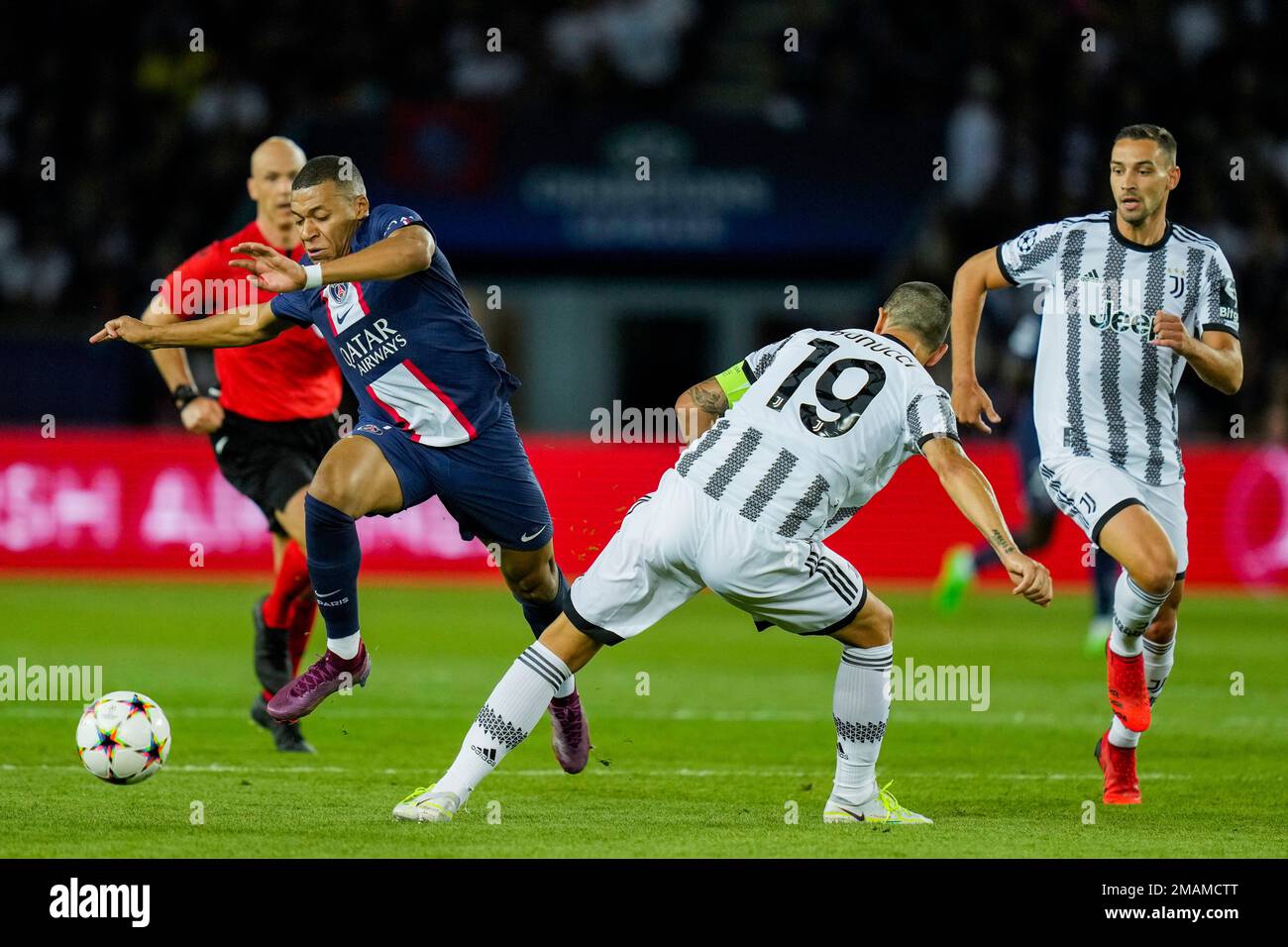 PSG's Kylian Mbappe, left, duels for the ball with Juventus' Leonardo ...