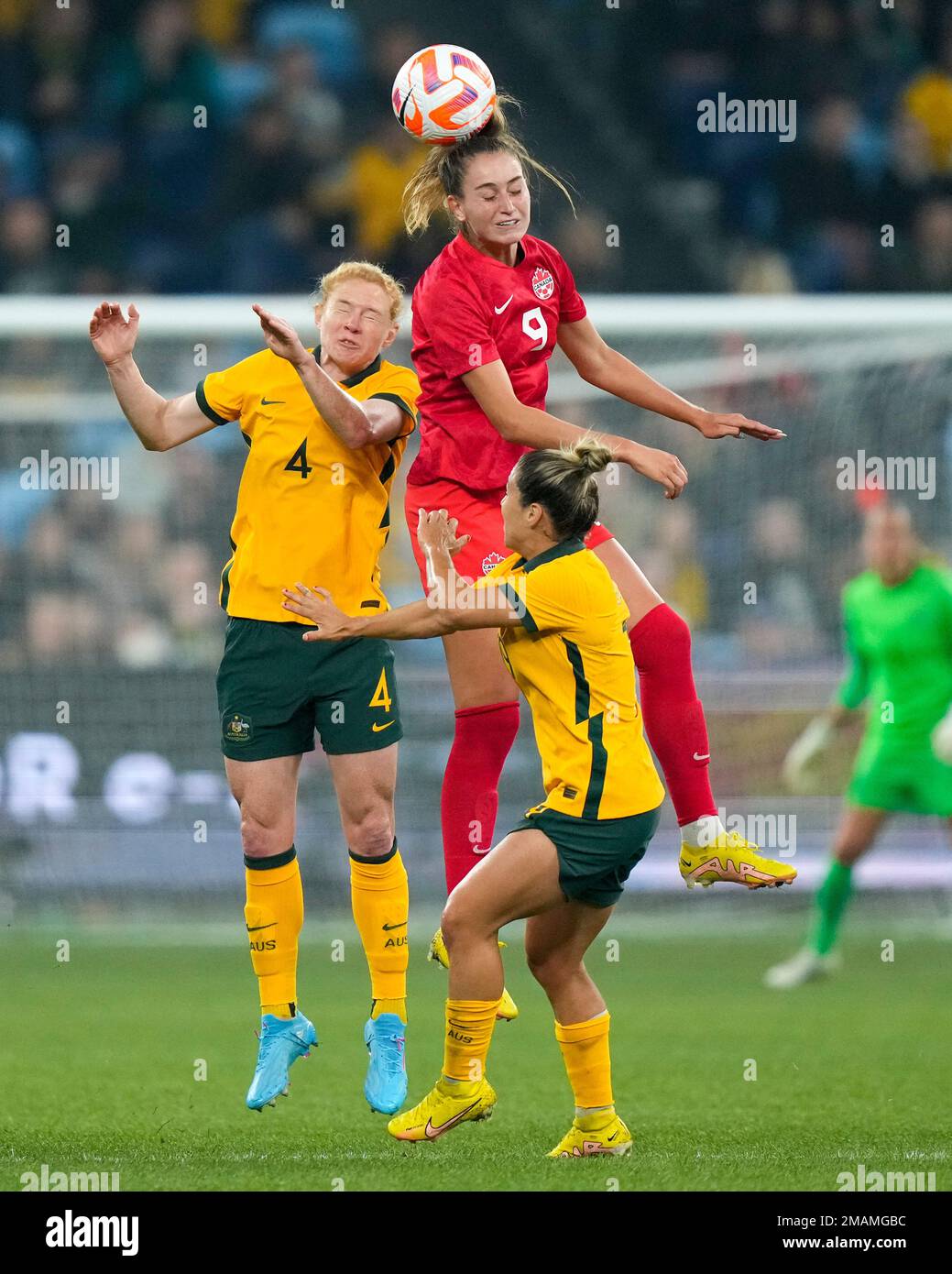 Canada's Jordyn Huitema heads the ball away from Australia's Clare ...
