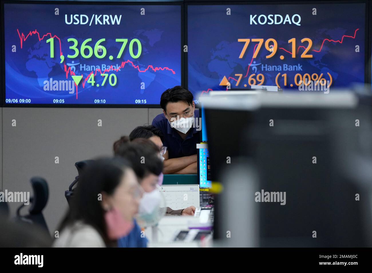 A currency trader watches monitors at the foreign exchange dealing room ...