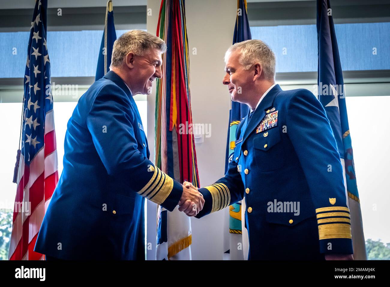 Admiral Karl Schultz, commandant of the U. S. Coast Guard, shakes hands ...