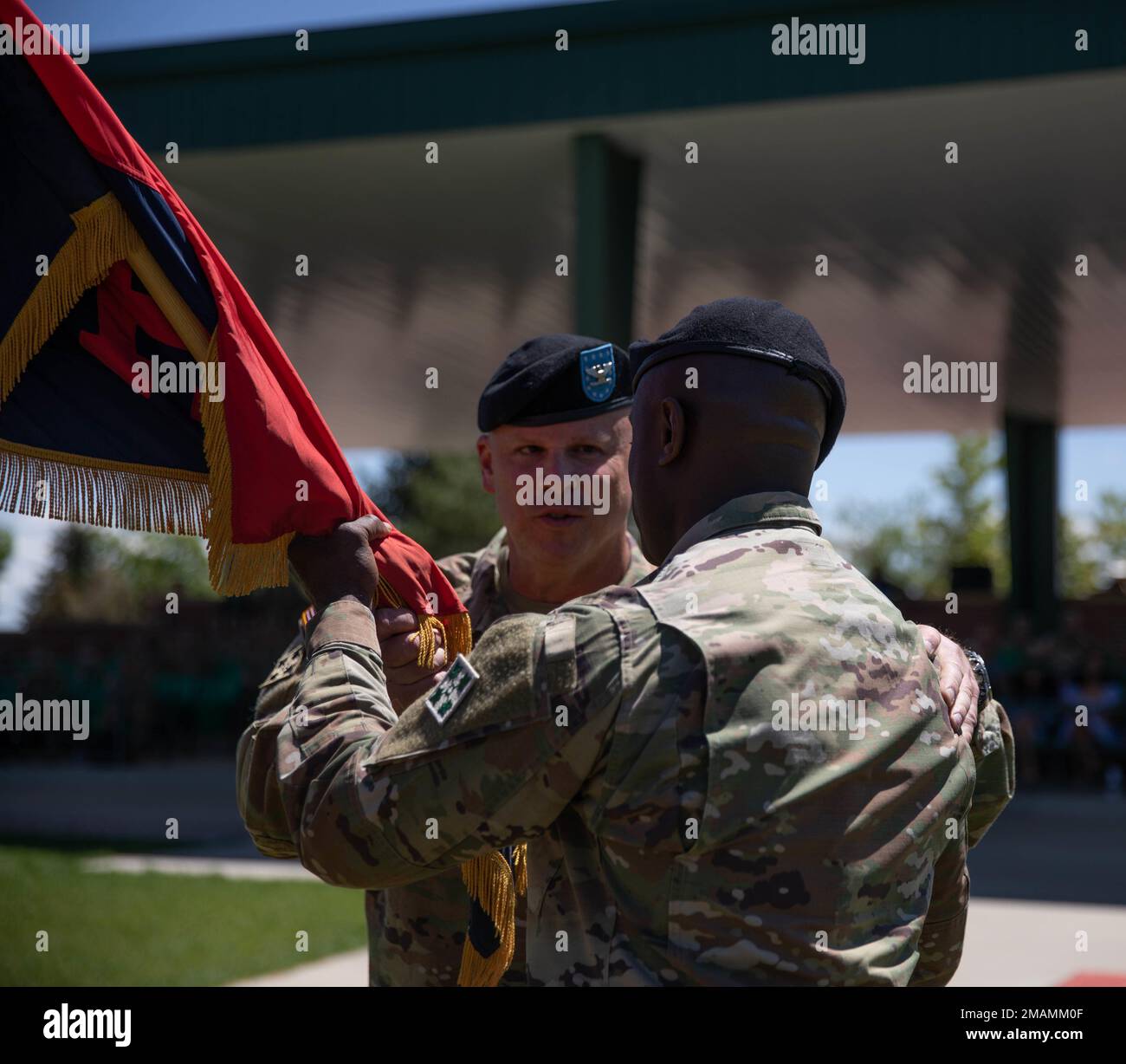 Col. Damon Wells, commander of 4th Infantry Division Artillery, hands over the battalion colors ...