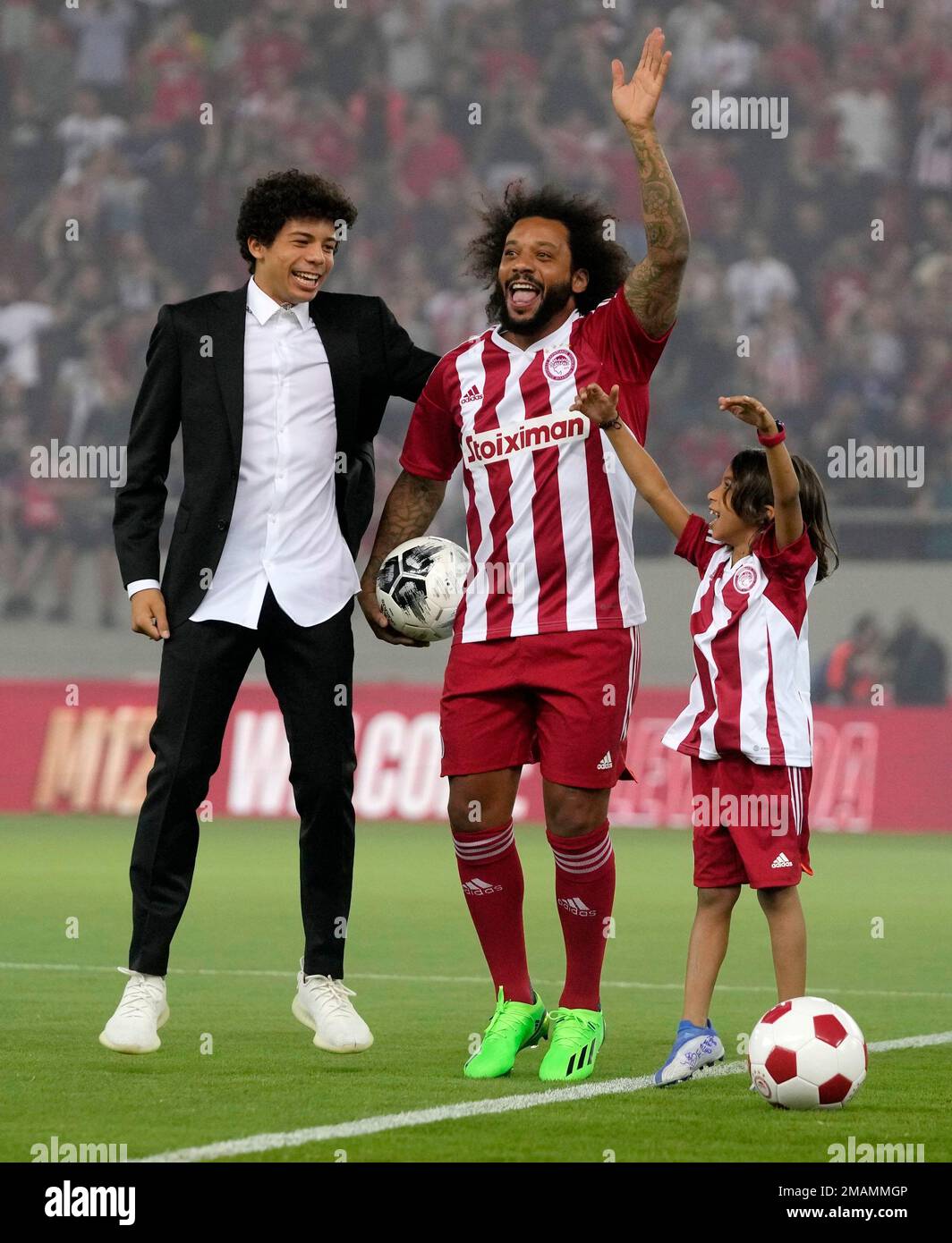 Brazilian soccer player Marcelo with his sons wave to the fans during ...