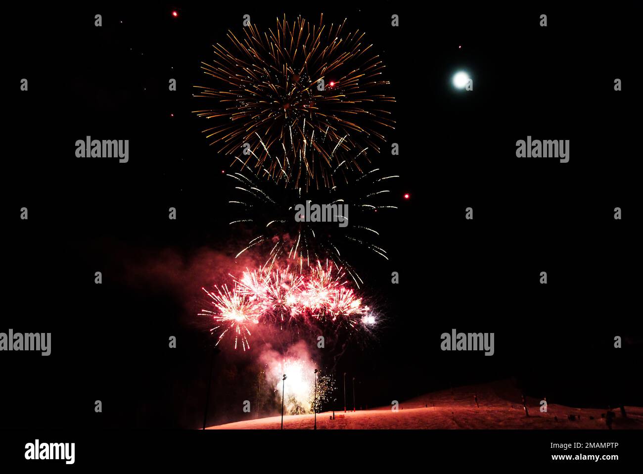 The fireworks in a night sky with moon Stock Photo - Alamy