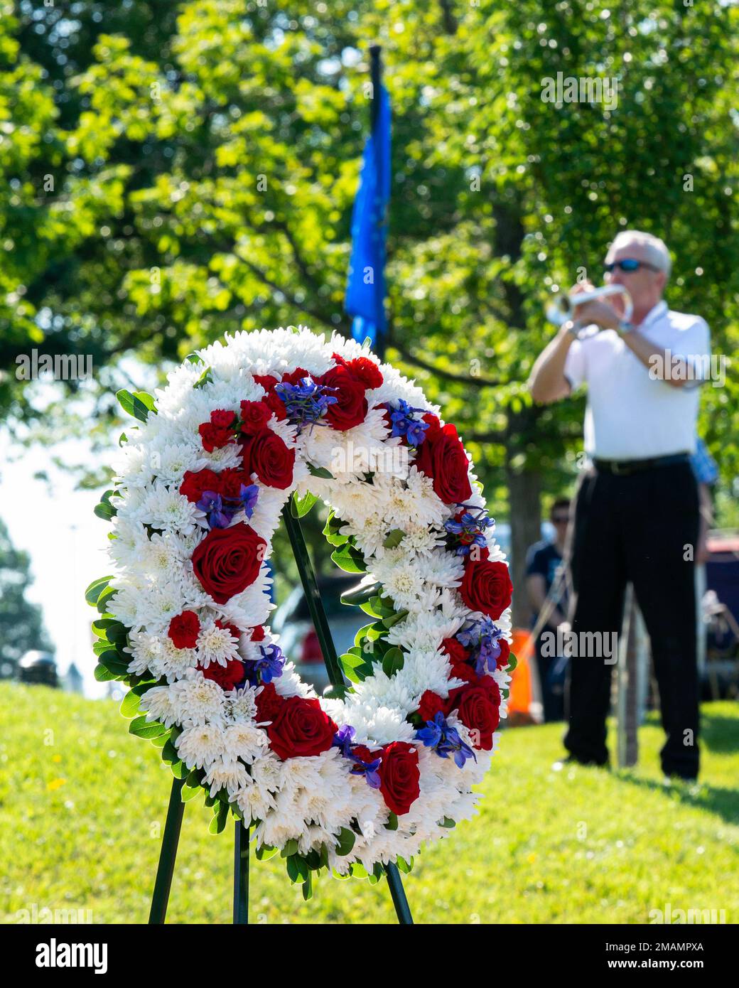 Tom Jacobs plays taps during a wreath laying at a Memorial Day ceremony ...