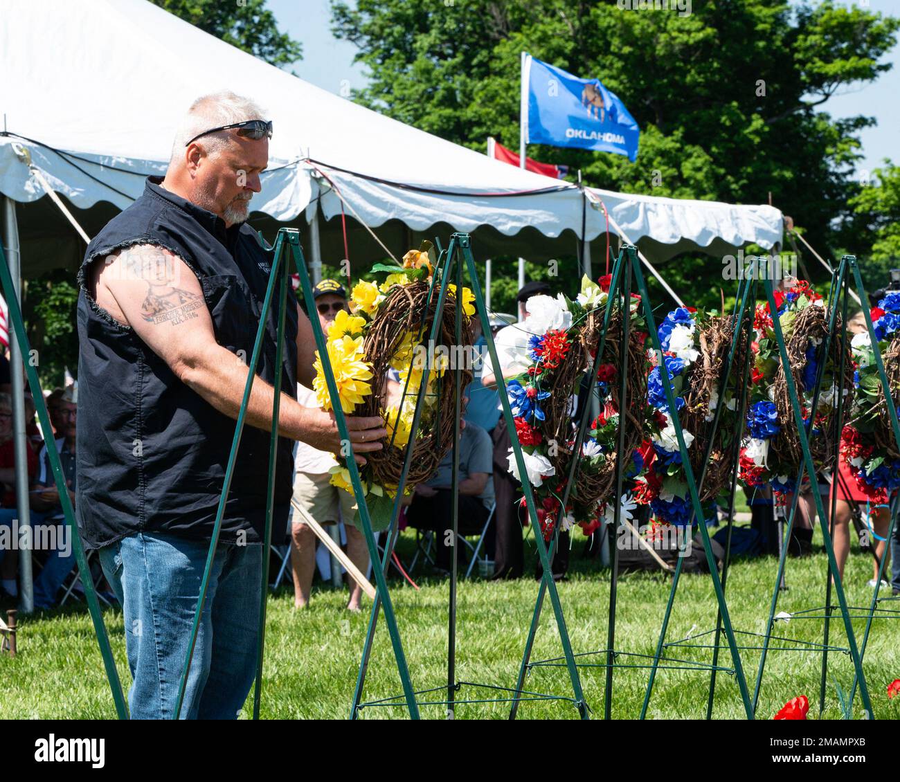James P. White, Sr. lays a wreath in honor of his son, Army Pfc. James ...