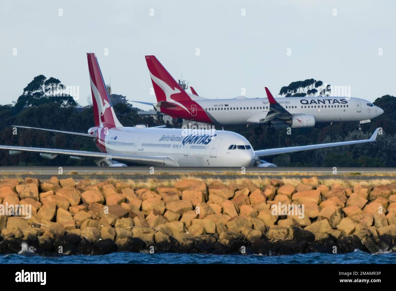 Qantas passenger jets cross as they taxi at Sydney Airport in Sydney ...