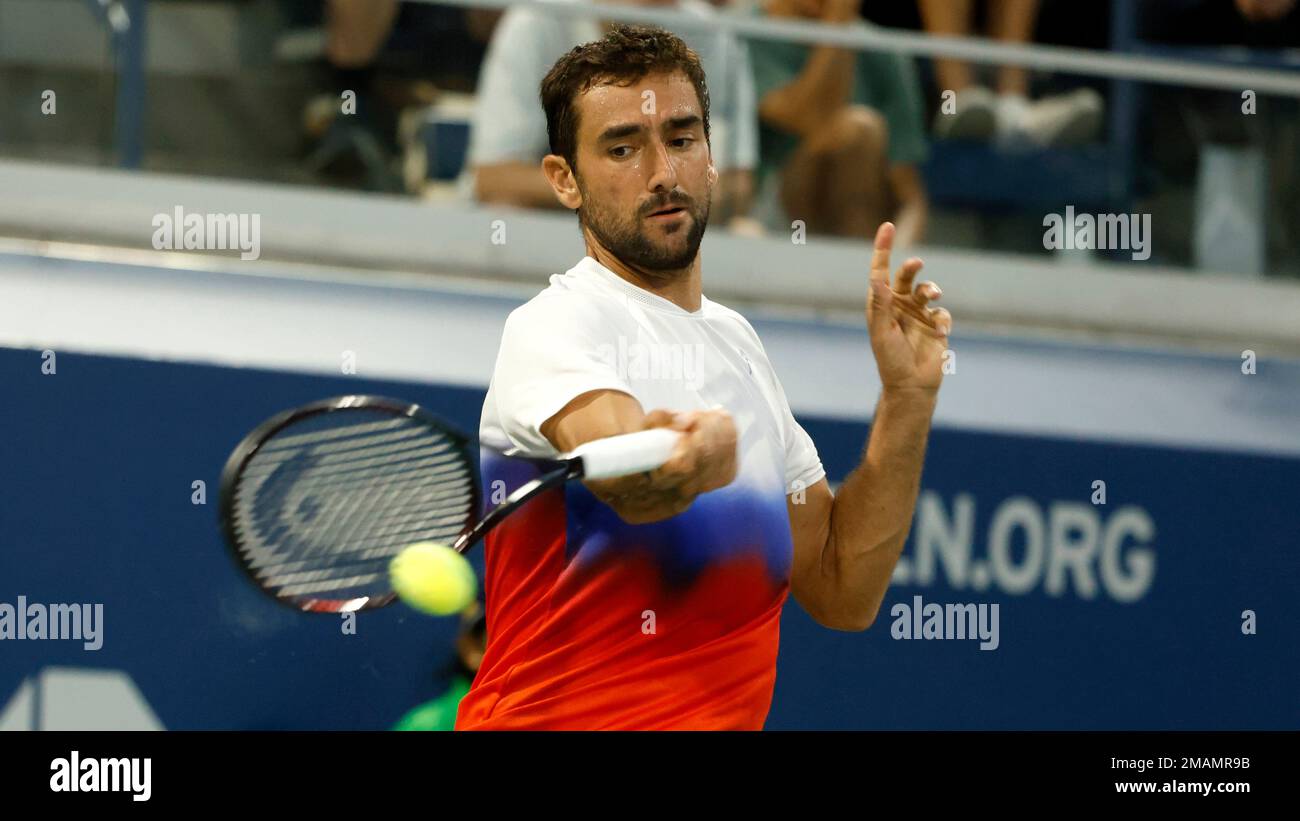 Marin Cilic, of Croatia, returns a shot to Daniel Evans, of the United ...