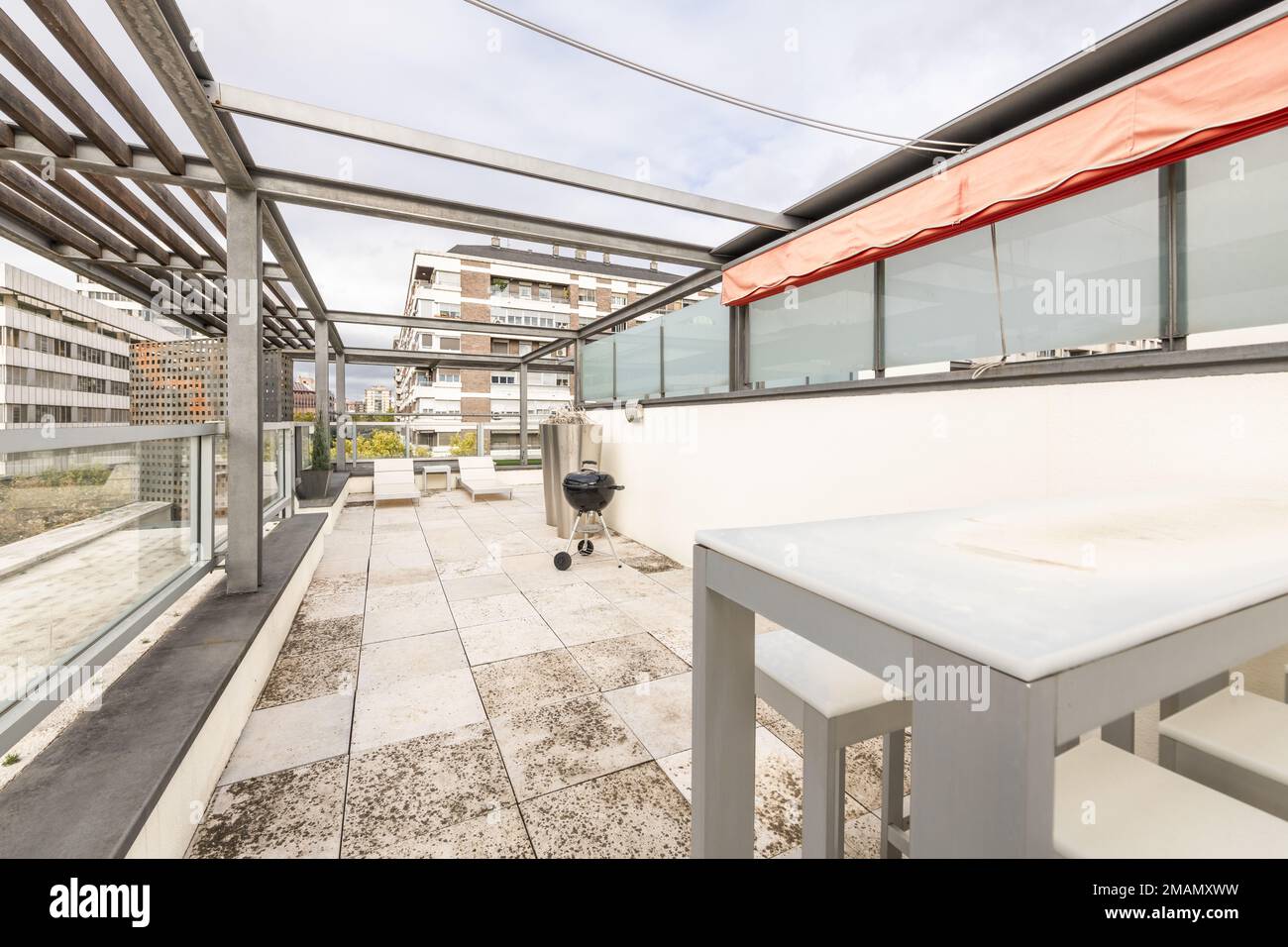 Terrace on the attic floor of a building with retractable awnings and ...