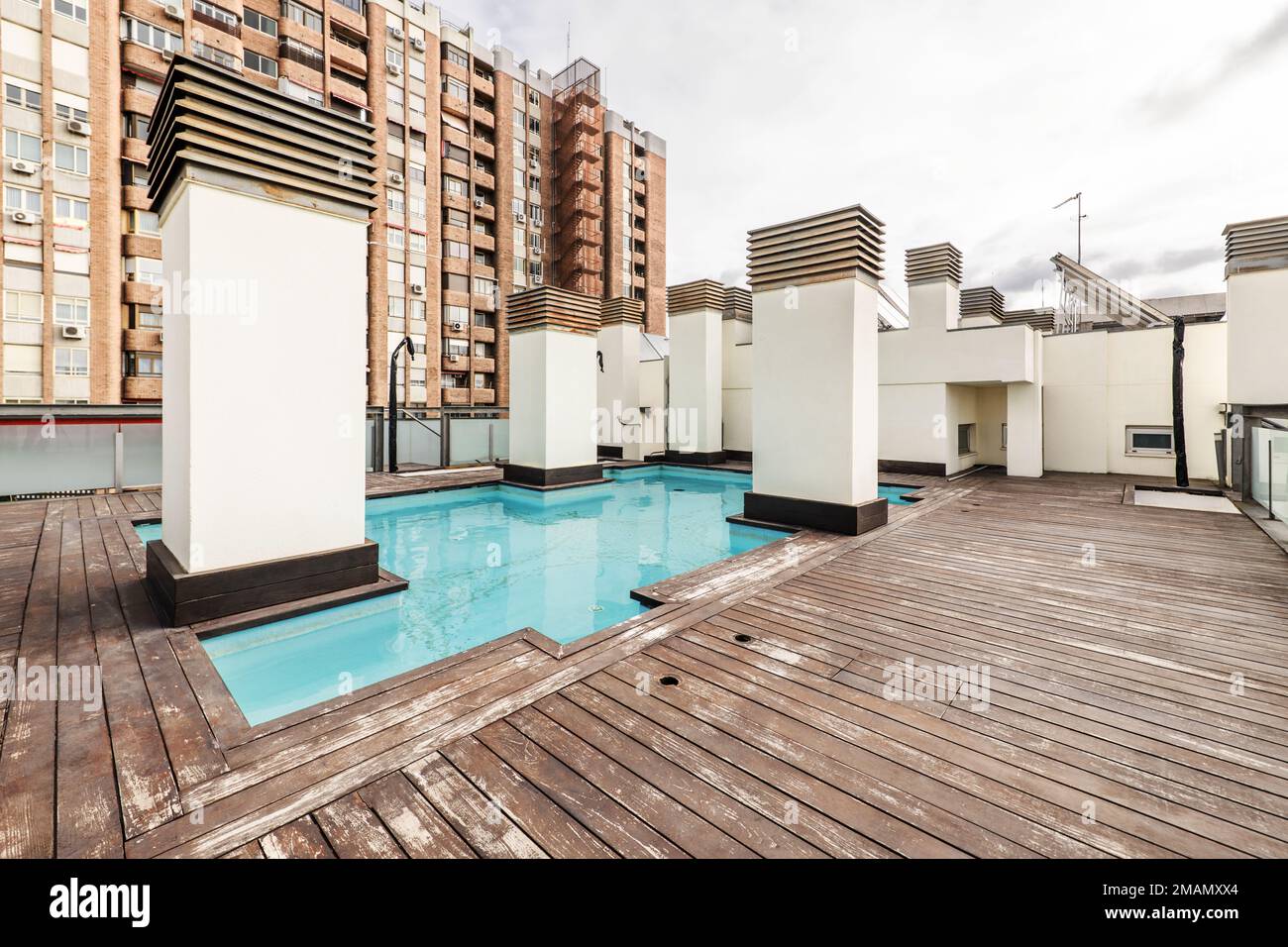 Rooftop terrace of a building with a summer pool between chimneys and ...