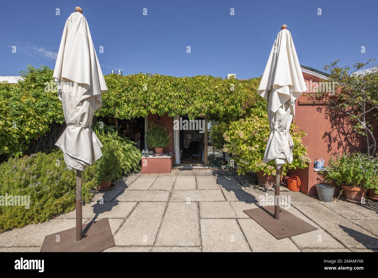 Rooftop terrace of a building with twin folded umbrellas, concrete ...