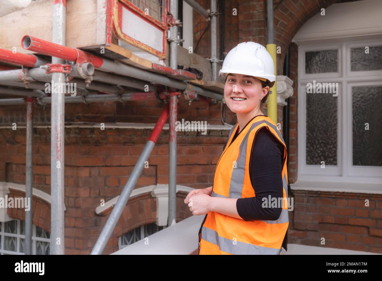 A smiley female civil engineer carrying out an inspection and ...