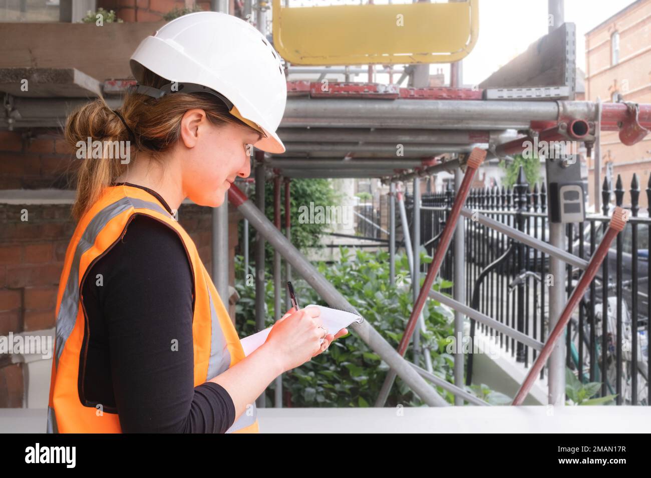 Smiley civil engineer lady carrying out an inspection and supervising a ...