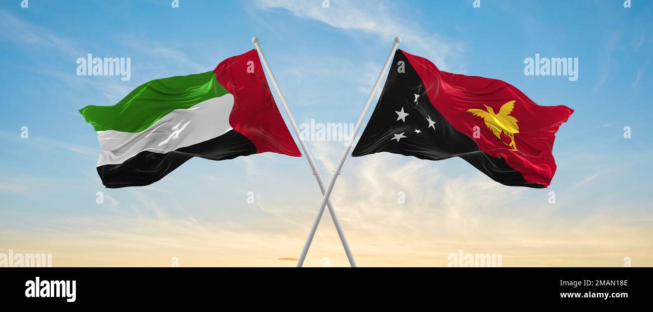 two crossed flags Papua New Guinea and United Arab Emirates waving in ...
