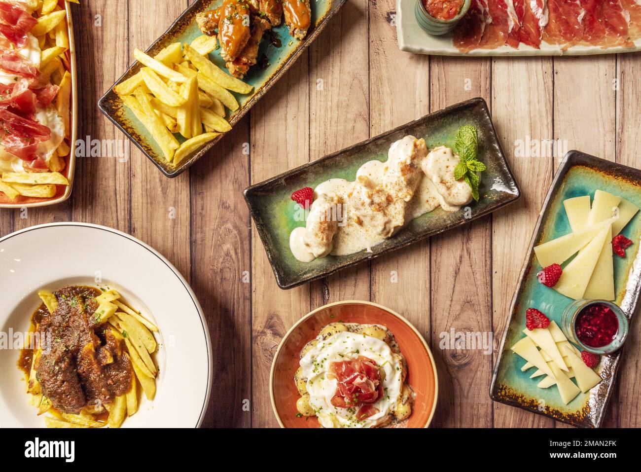 Set of typical traditional Spanish food tapas recipes, broken eggs with ...