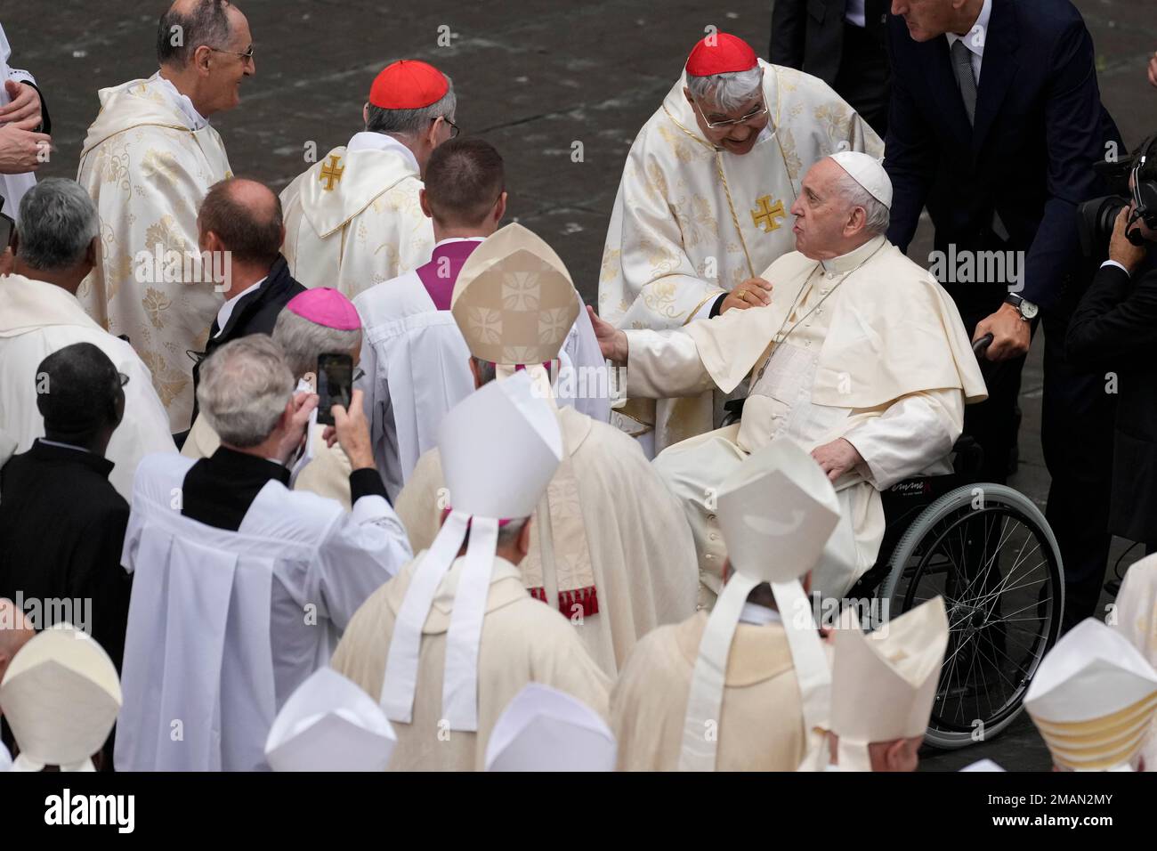 Pope Francis greets cardinals and bishops as he leaves after the ...