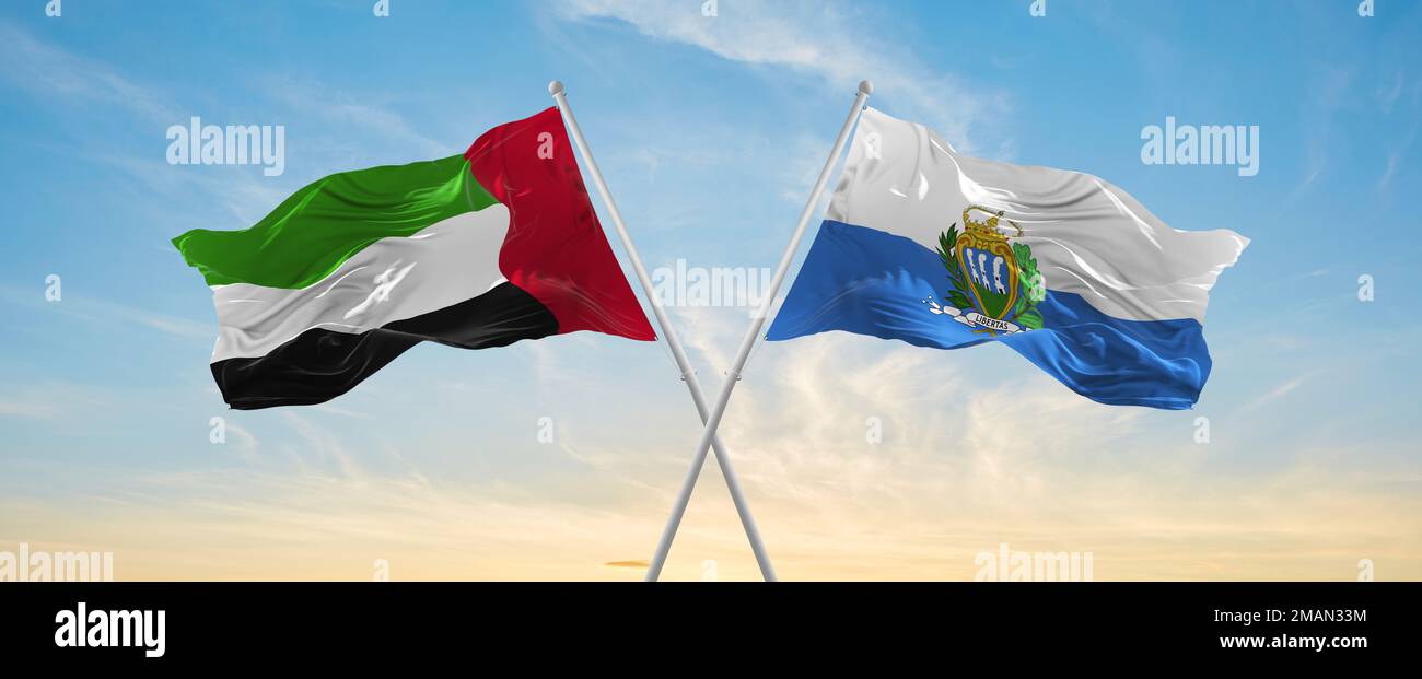 two crossed flags San Marino and United Arab Emirates waving in wind at ...