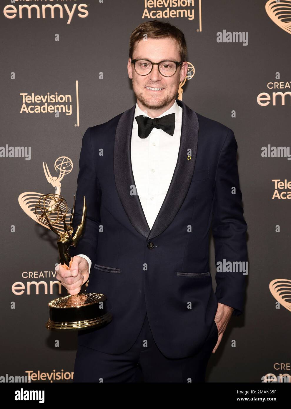Michael Cheeseman poses with the Emmy for outstanding cinematography ...
