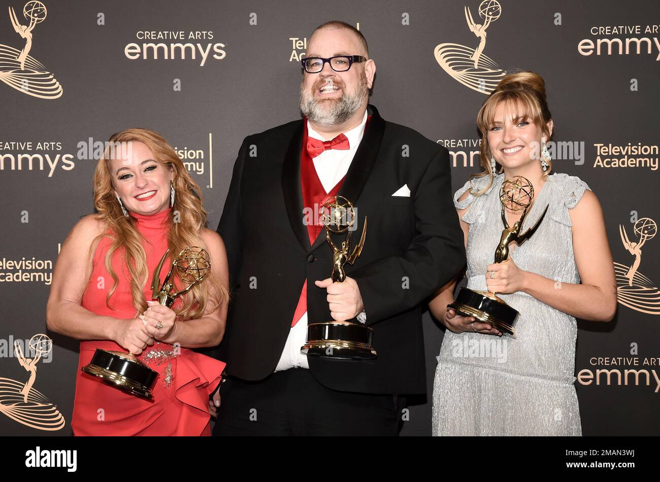 Kat Elmore, left, Jeffrey Marx, and Laura Ritchie pose with the Emmy ...