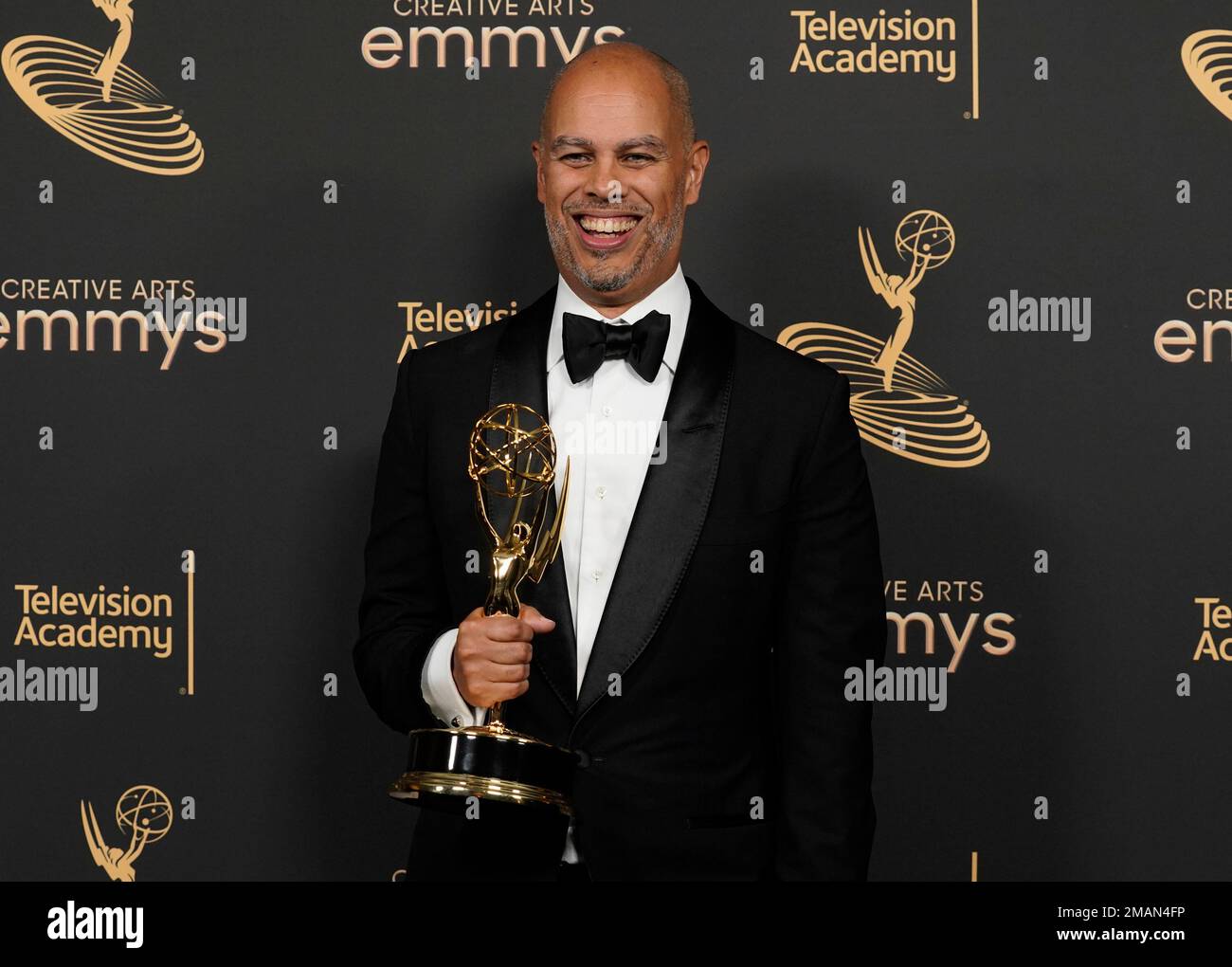 Jesse Collins poses in the press room with the award for outstanding ...