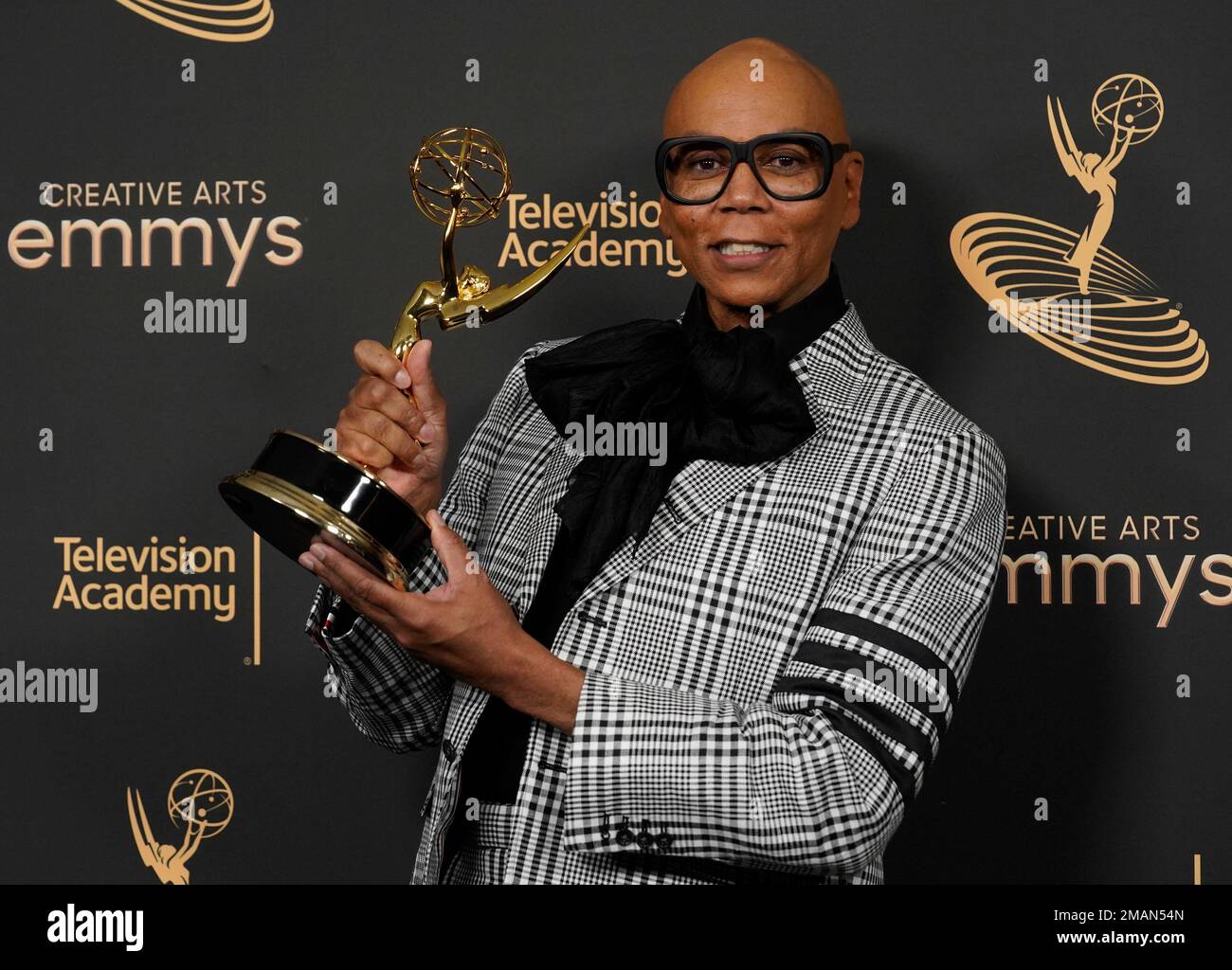 RuPaul poses in the press room with the award for outstanding host for ...