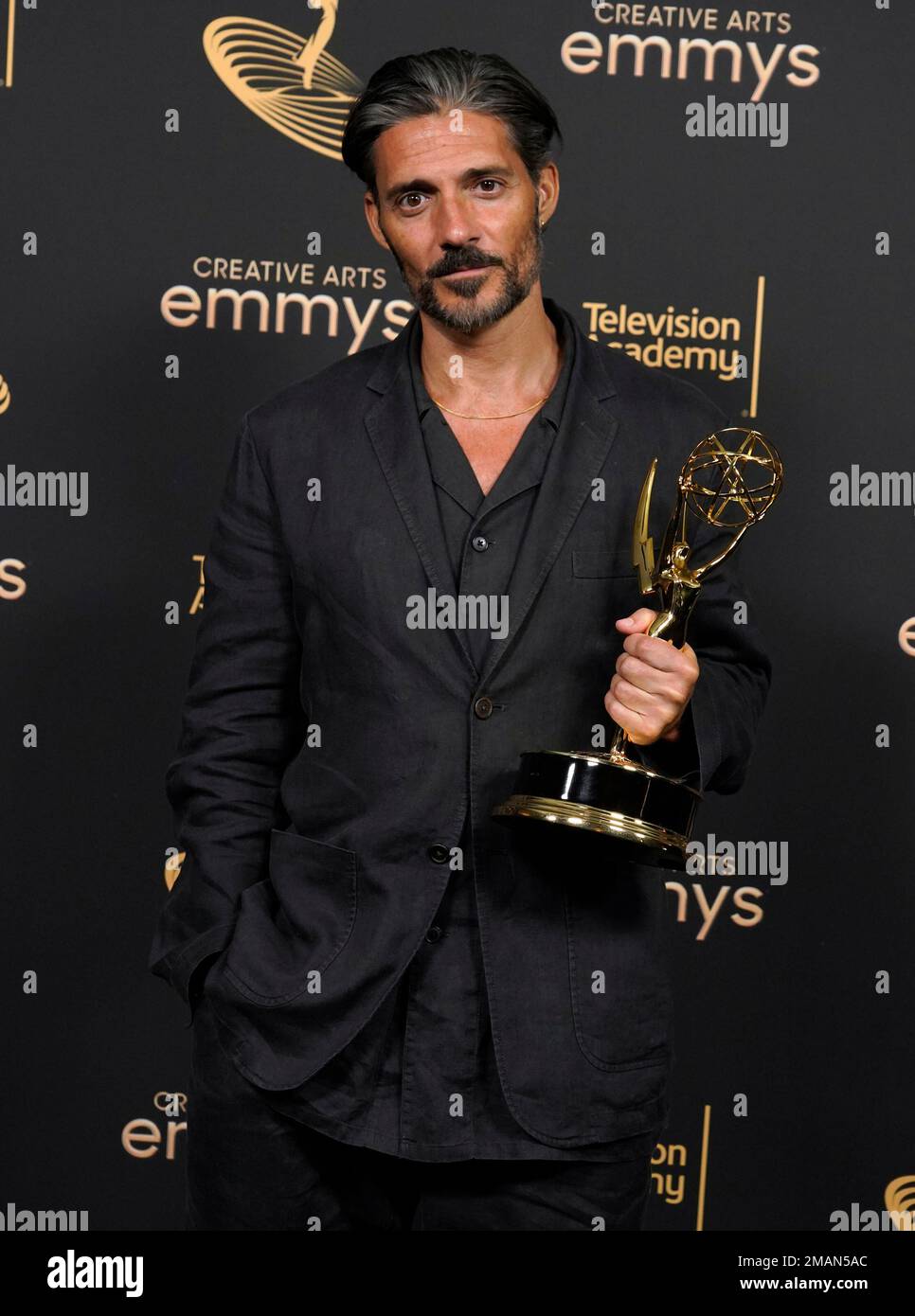 Alberto Mielgo poses in the press room with the award for outstanding ...