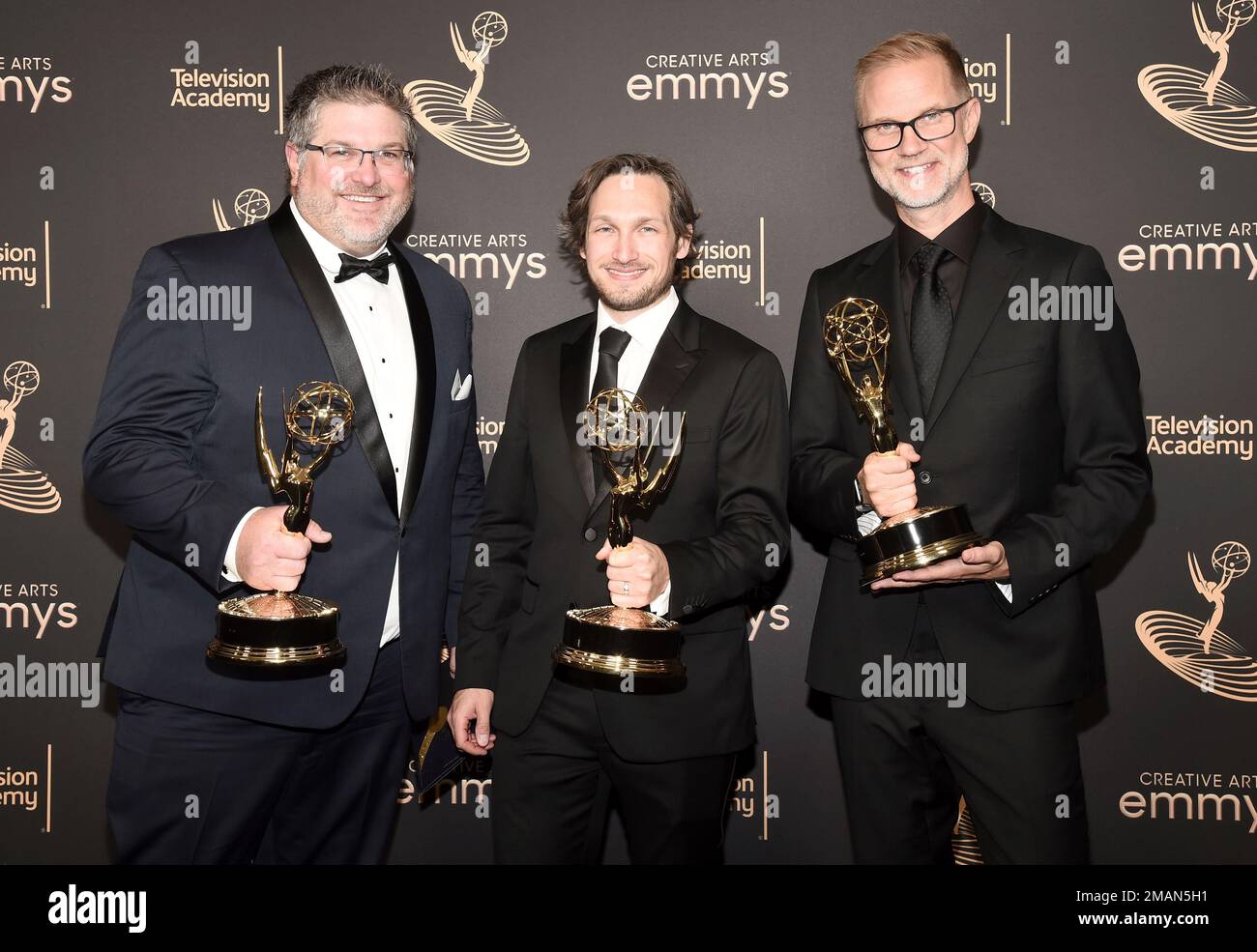 Matthew Cotter, Noah Mitz, and Bryan Klunder pose with the Emmy for ...