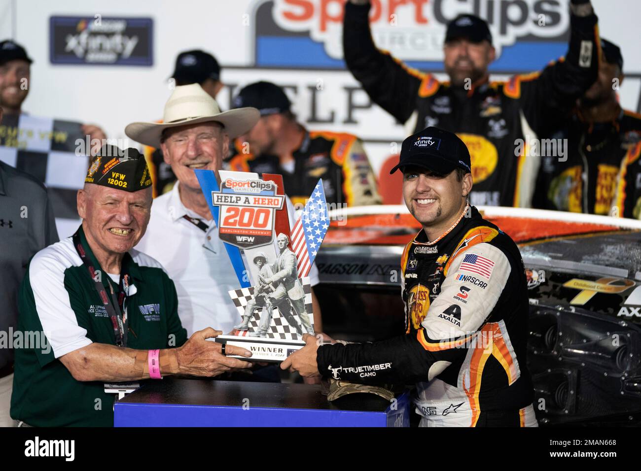 Noah Gragson, right, receives the trophy after he won the NASCAR ...