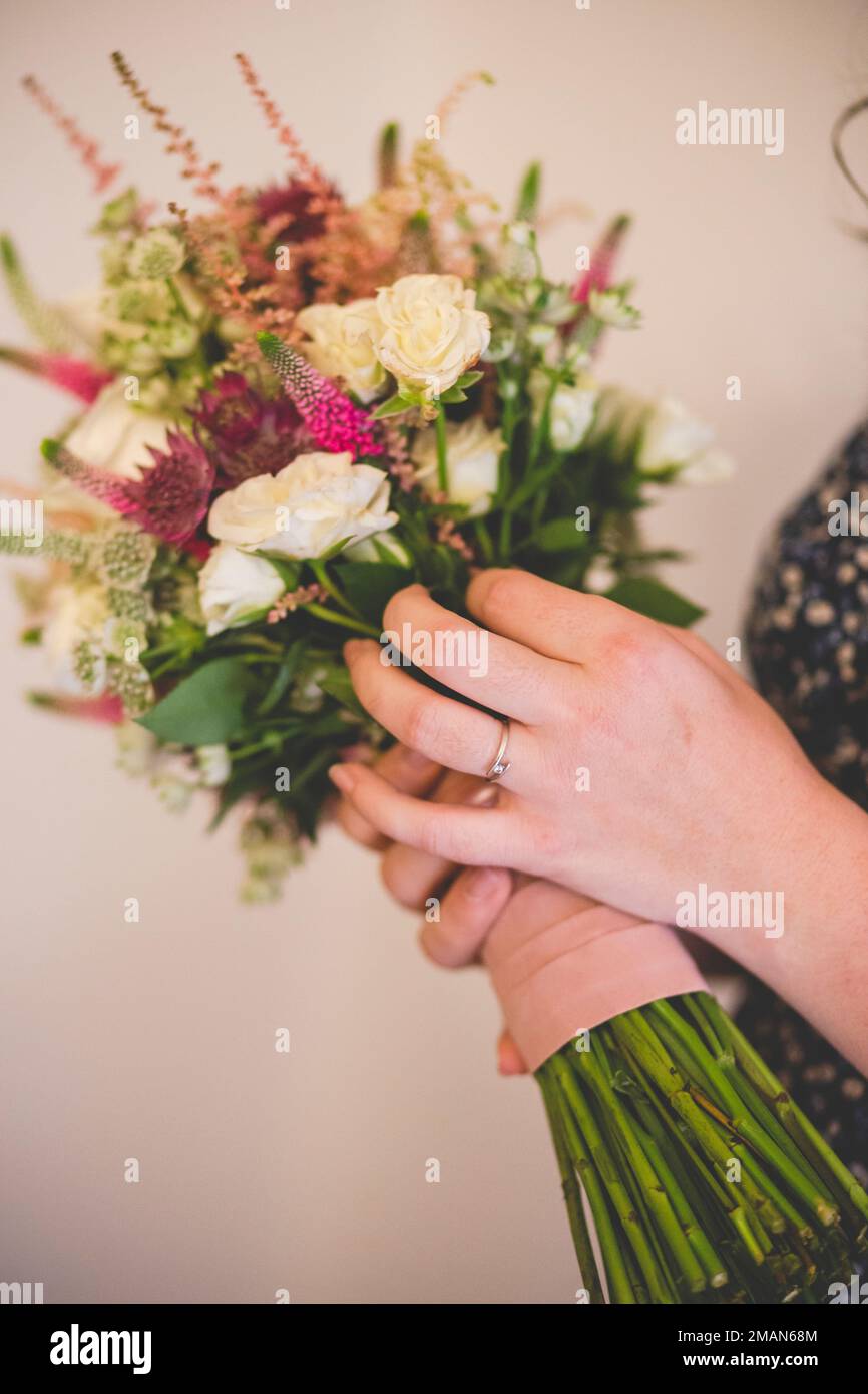 Flowers bouquet with female hand Stock Photo - Alamy