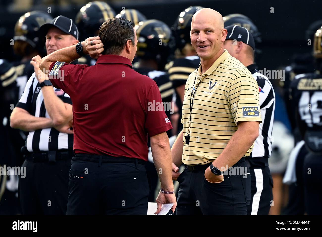 Vanderbilt coach Clark Lea, right, talks with Elon coach Toni Trisciani ...