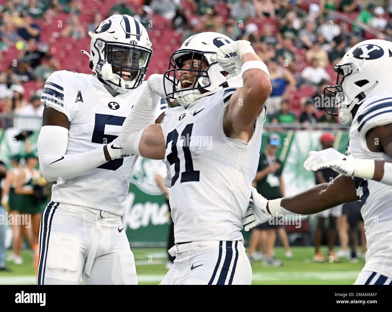 BYU linebacker Max Tooley (31) celebrates after returning an ...