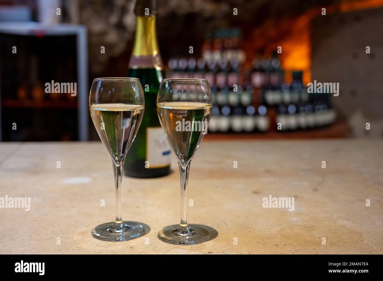 Tasting of rose champagne sparkling wine produced by traditional method in dark underground ...