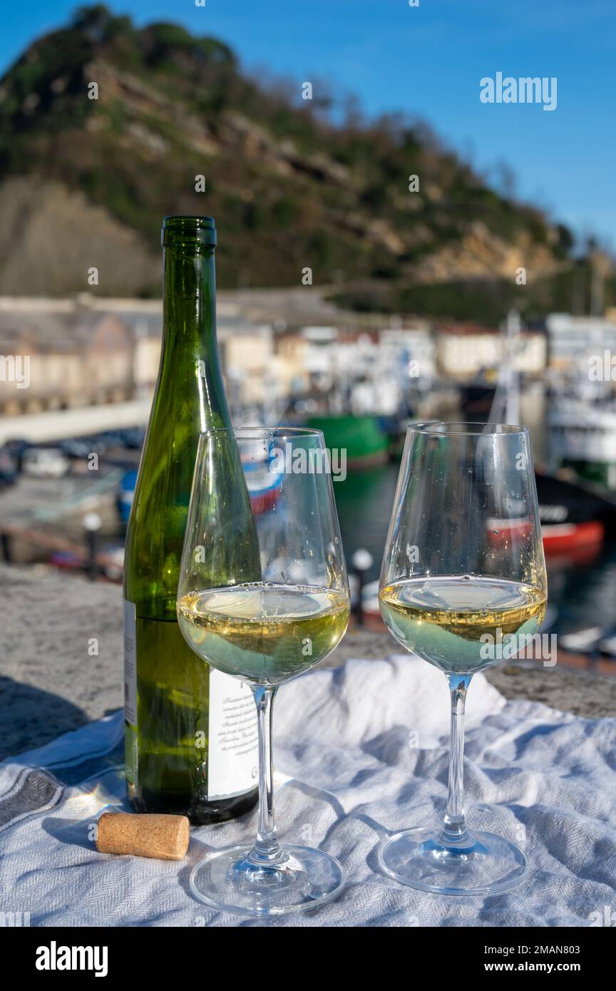 Tasting of txakoli or chacolí slightly sparkling very dry white wine ...