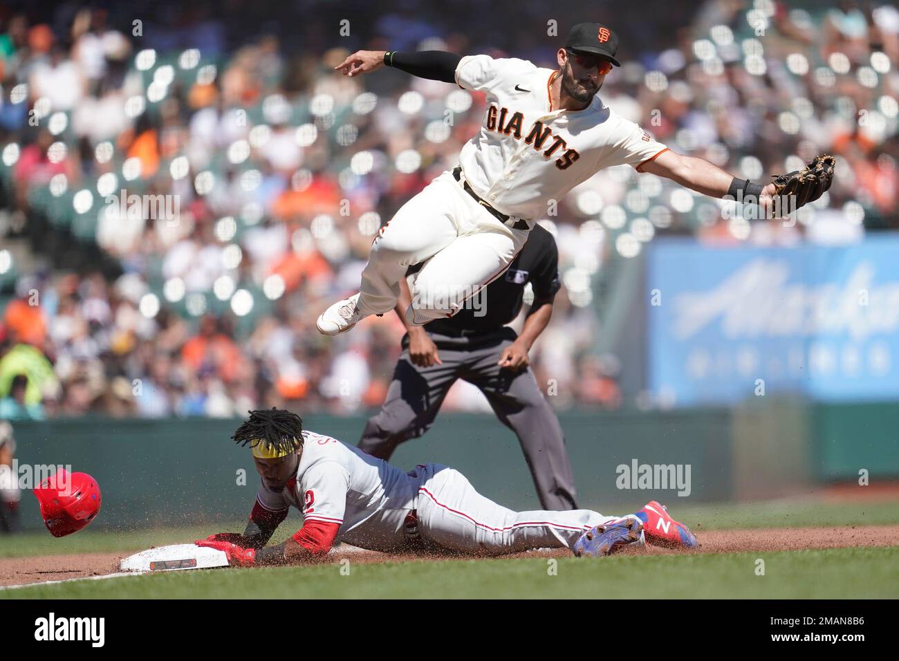 Philadelphia Phillies' Jean Segura, bottom, steals third base under San ...