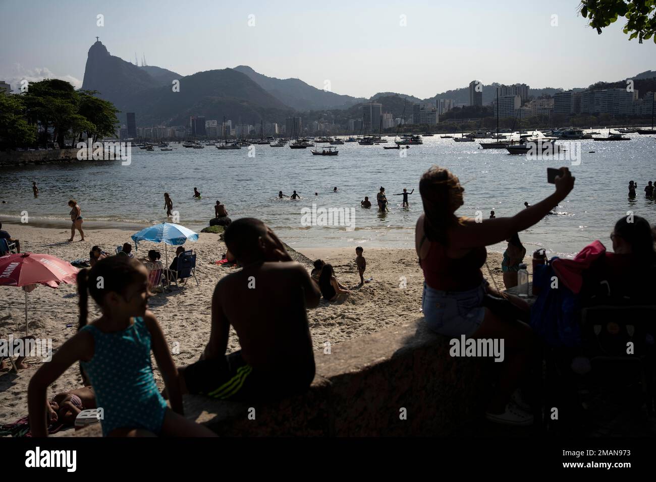 Beachgoers sunbathe and swim in the waters of Guanabara Bay, in the ...