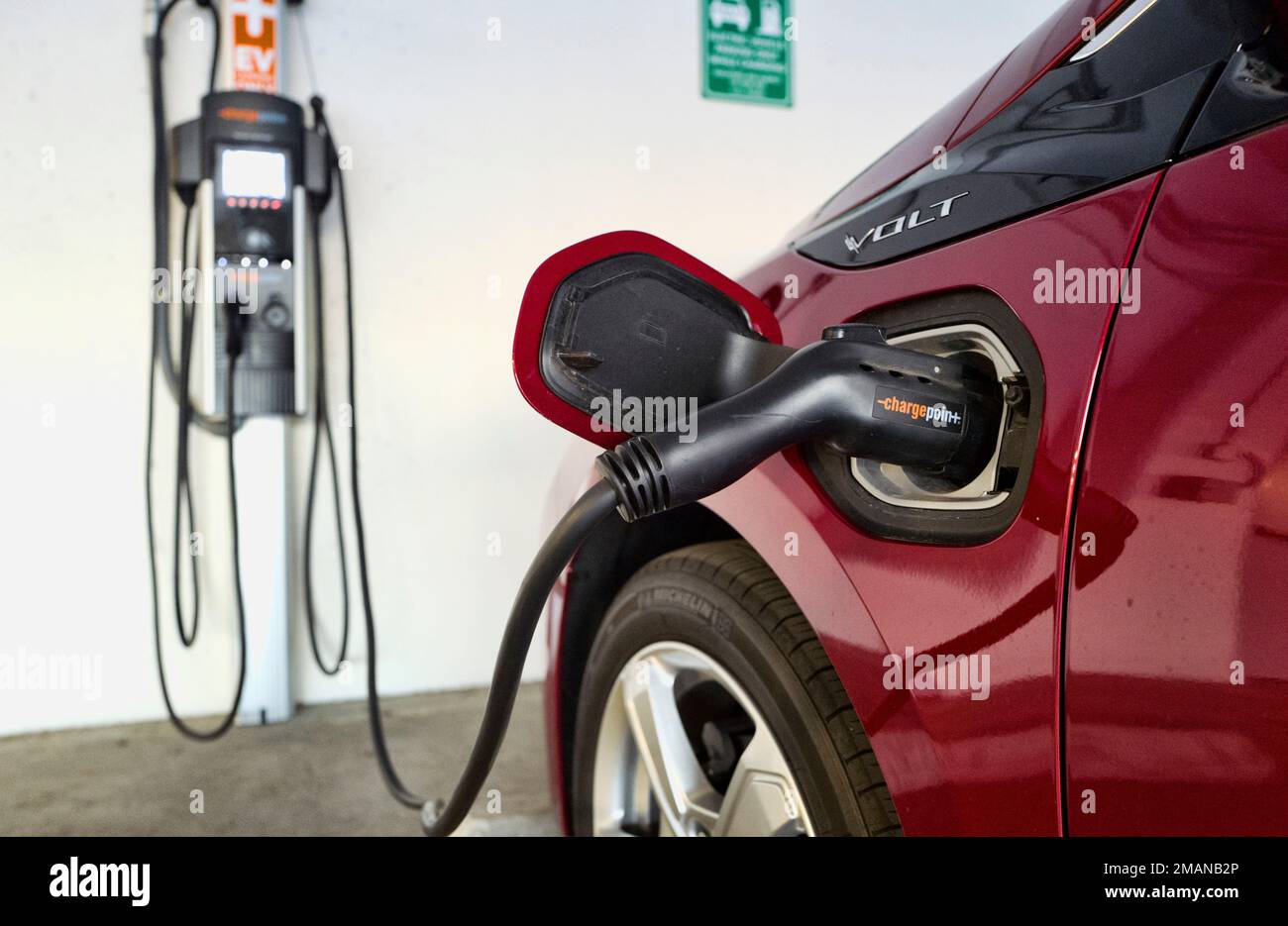 FILE - A Chevrolet Volt hybrid car is seen charging at a ChargePoint ...