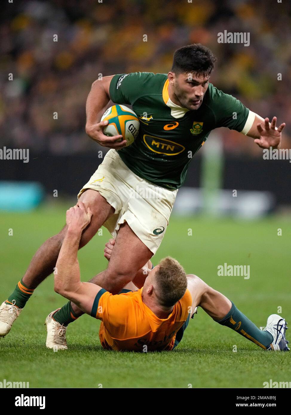 South Africa's Damian de Allende, top, runs over Australia's Reece ...
